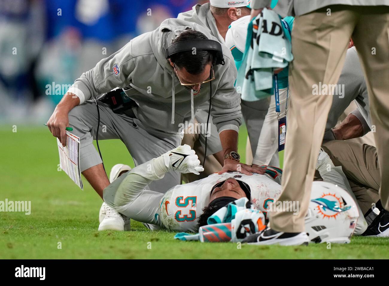 Miami Dolphins head coach Mike McDaniel checks on linebacker Cameron ...