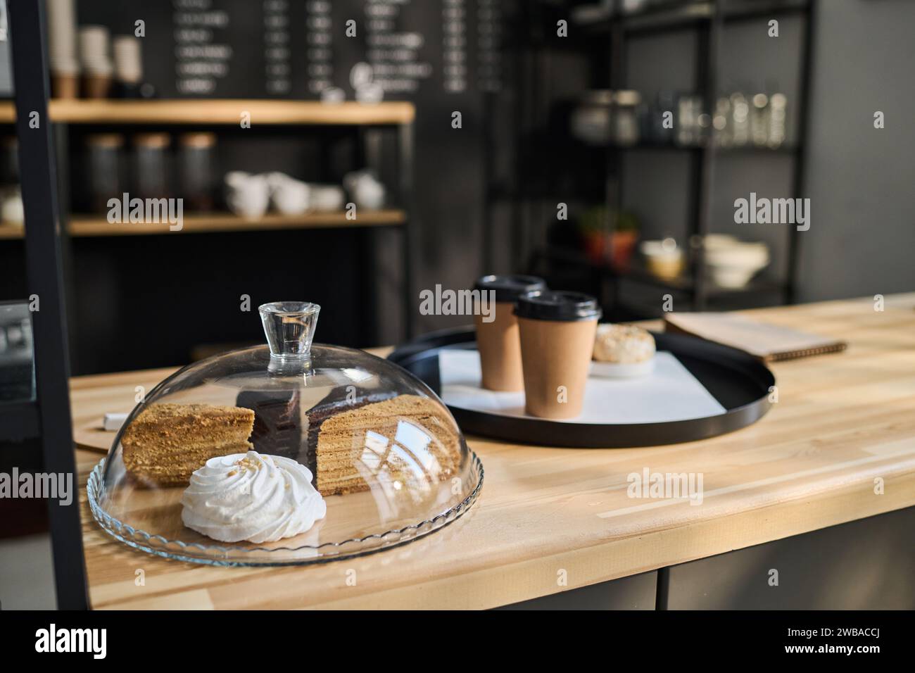 Transparent cloche covering fresh appetizing sweet snacks standing on ...