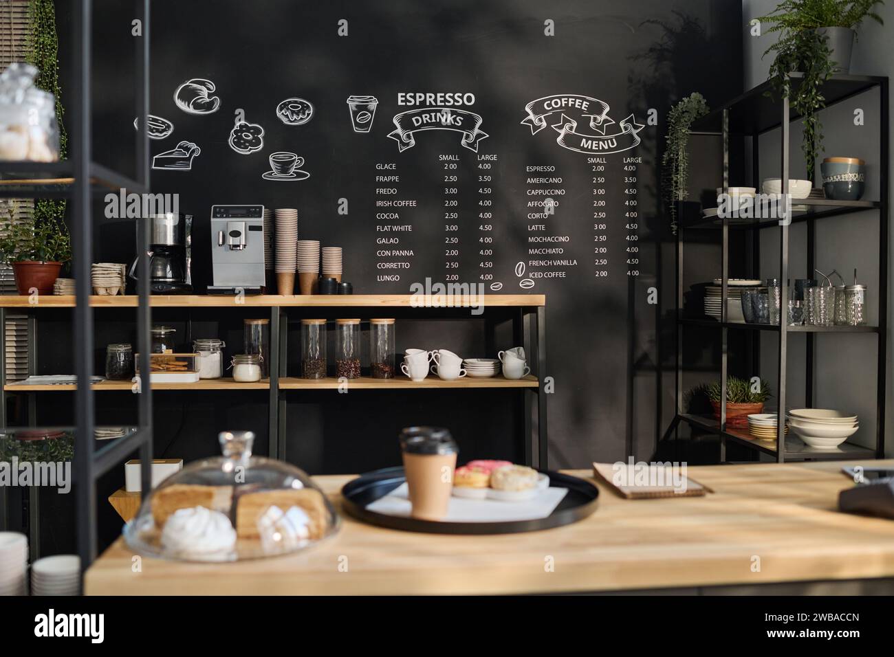 Focus on large black board with menu and list of drinks sold in modern ...