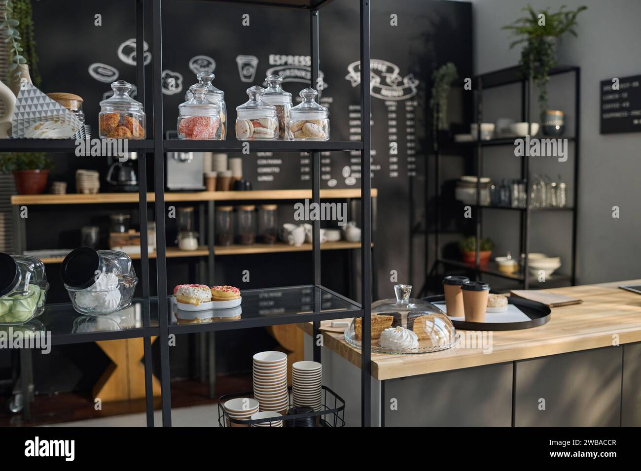 Large display and wooden counter with appetizing sweets, cookies and ...