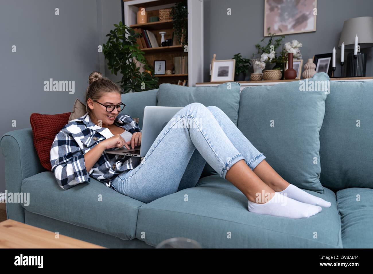 Young freelance business woman working at home on laptop as product ...