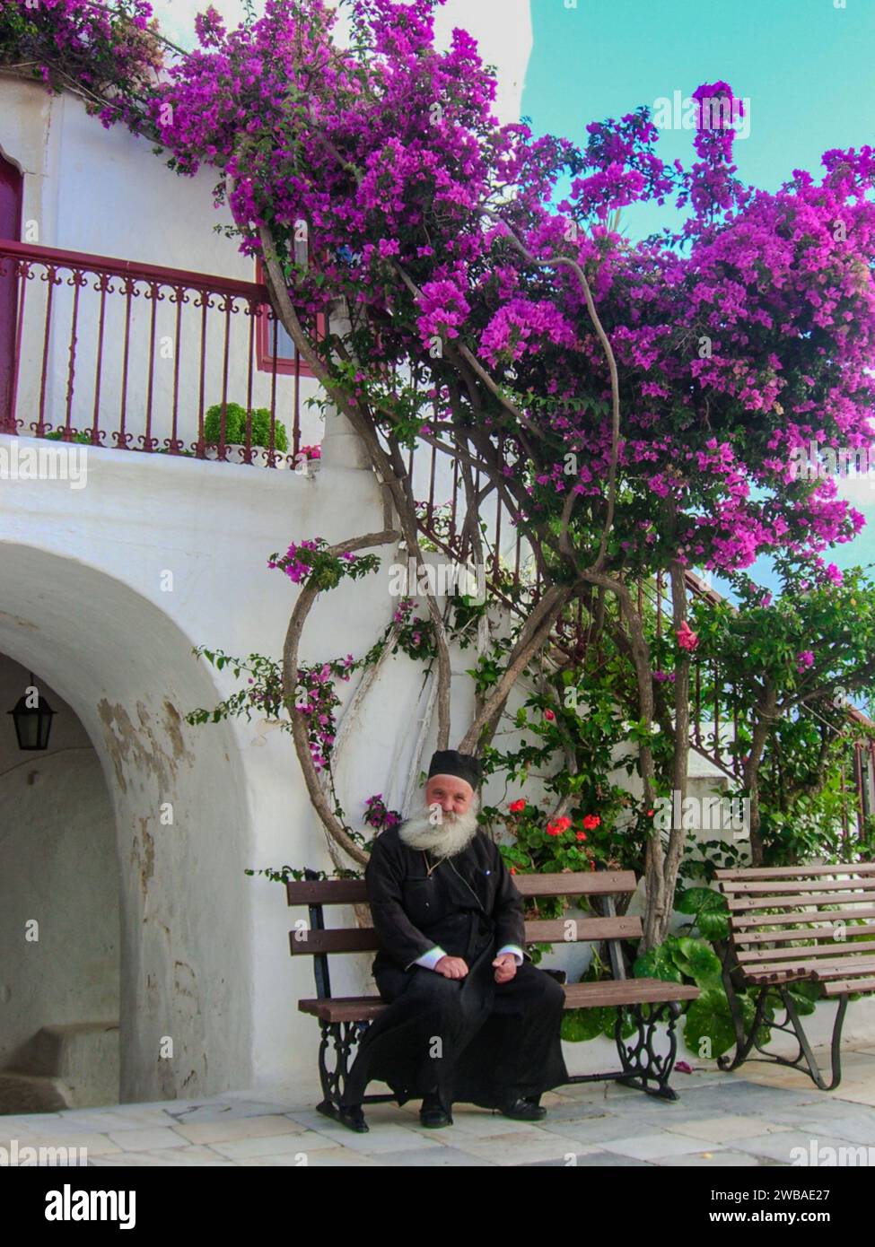 Portrait of monk with a big smile on his face in the courtyard of the ...