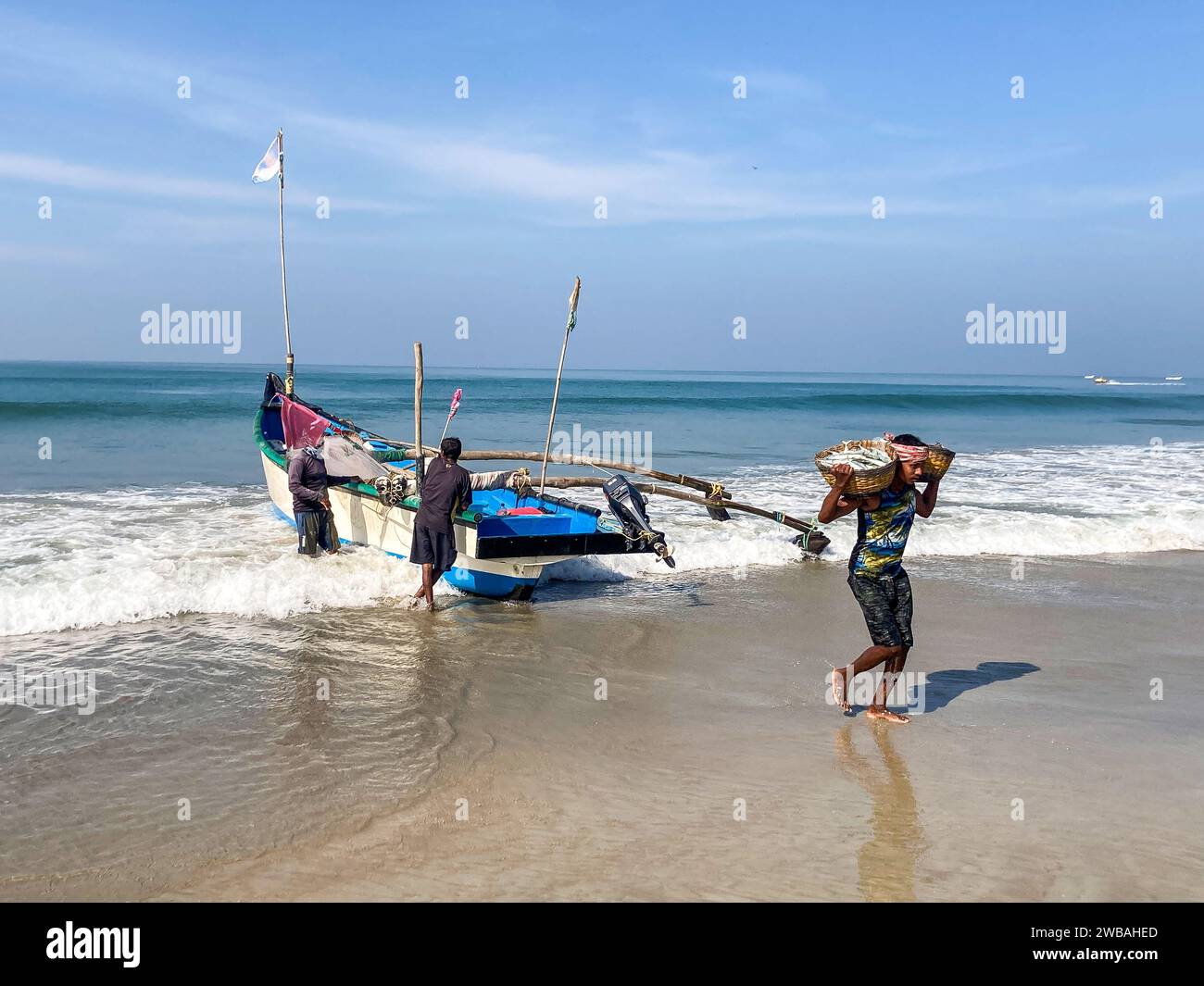 Fishermen on the beach at Benaulim in Goa, India, pull their nets ...