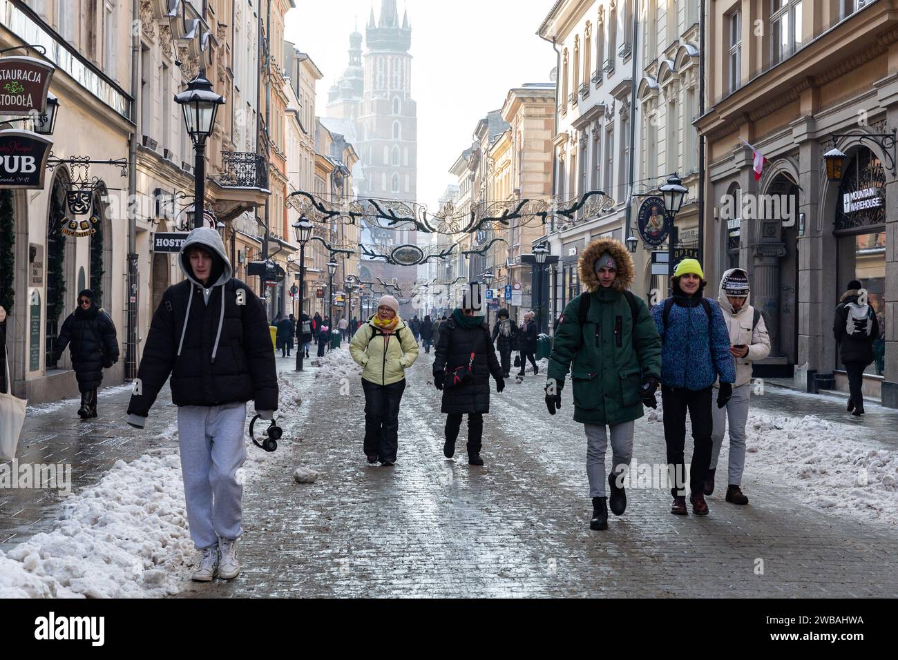 Krakow, Poland. 9th Jan, 2024. People dressed in winter covers walk on ...