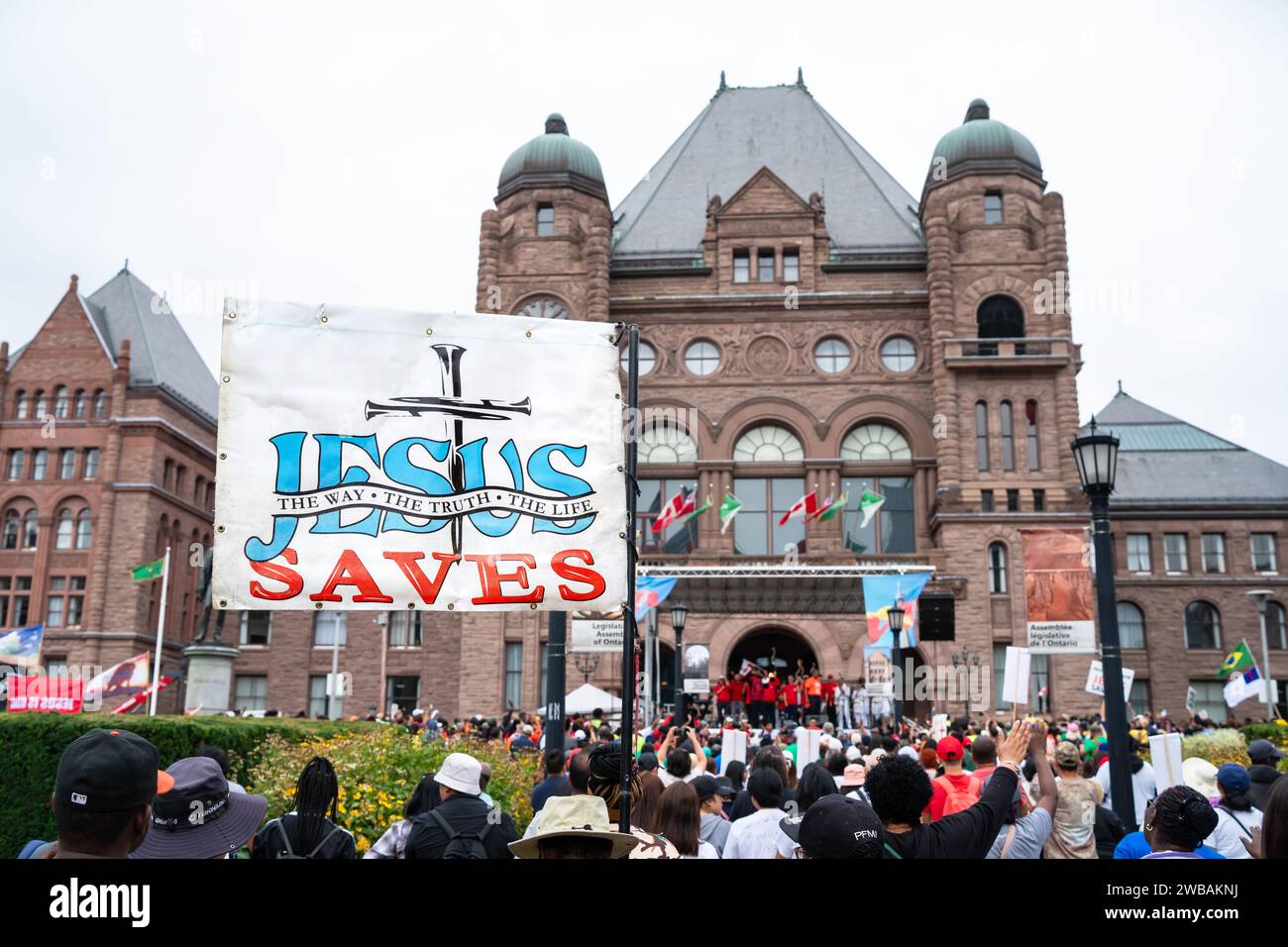 A sign reading "Jesus Saves" at the Jesus in the City parade in Toronto ...