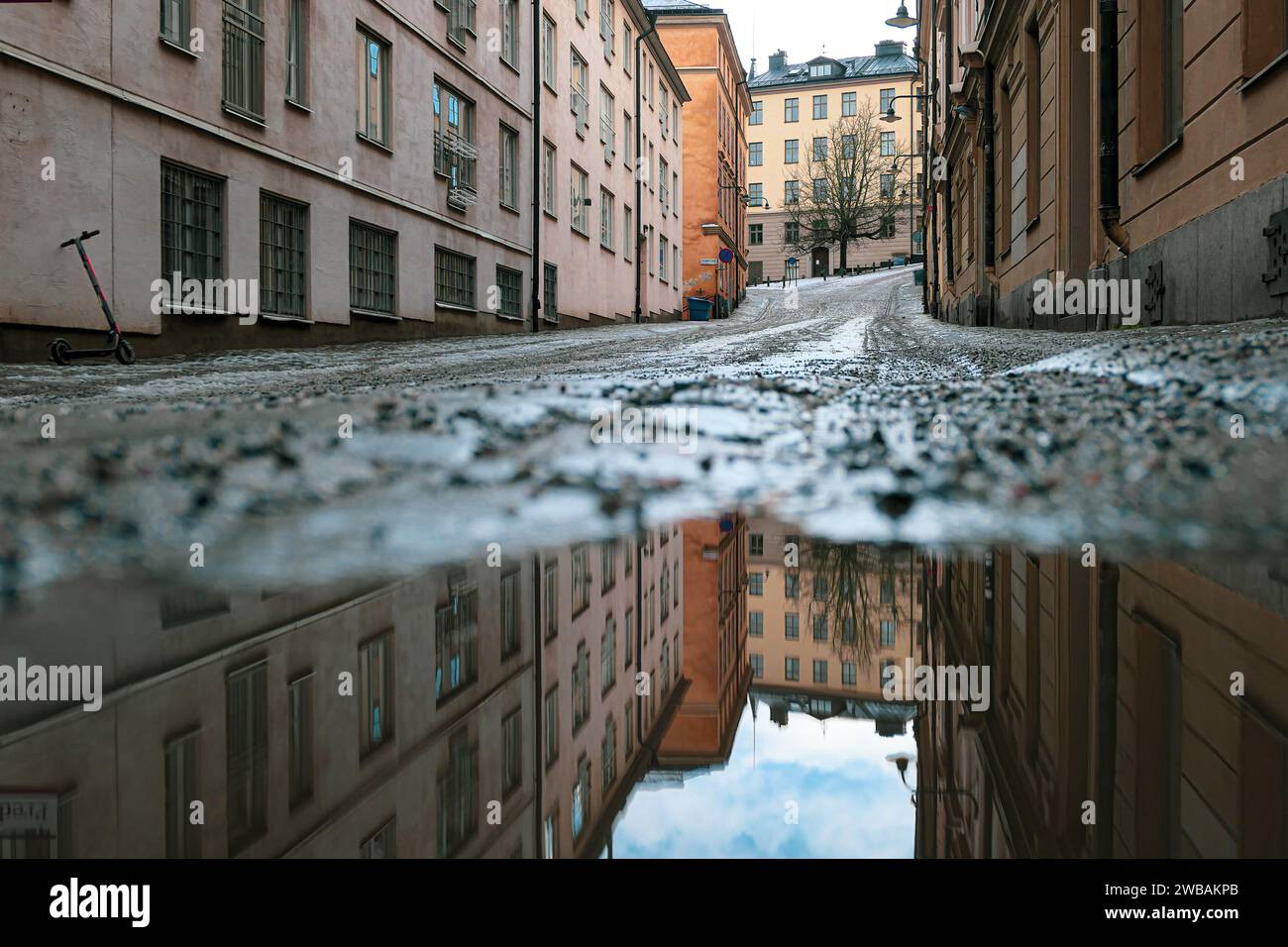 Puddle on alley street hi-res stock photography and images - Alamy