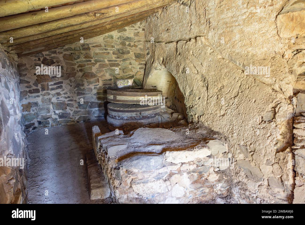 Old and out of use water mill with focus on the millstone Stock Photo ...