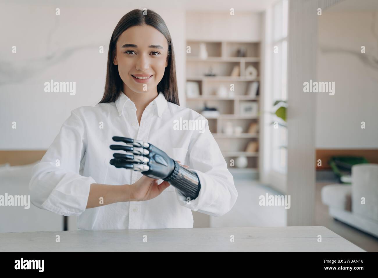 Confident young woman showcasing her bionic arm, embodying the seamless ...