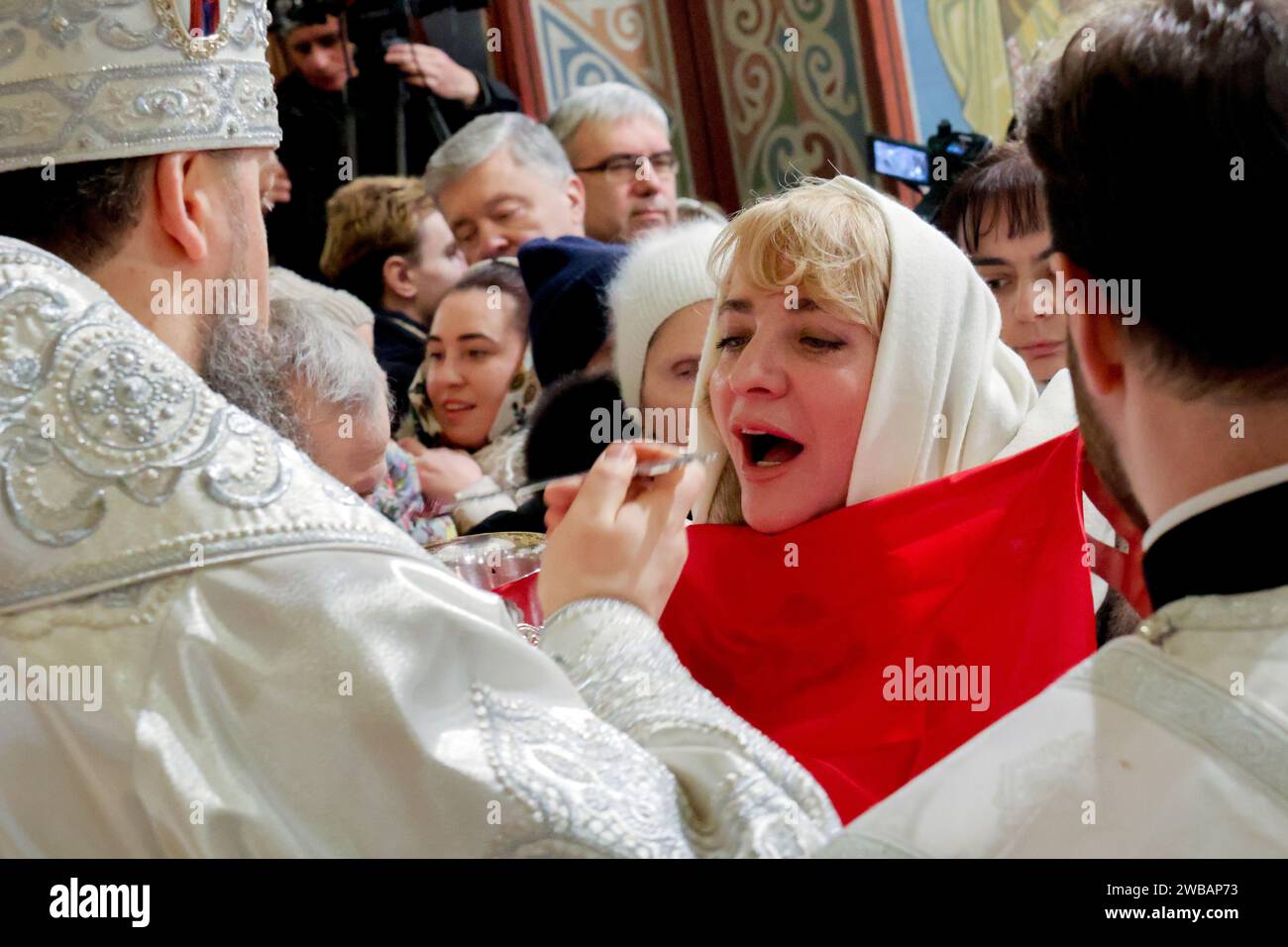 KYIV, UKRAINE - JANUARY 6, 2024 - A priest shares the Holy Communion ...