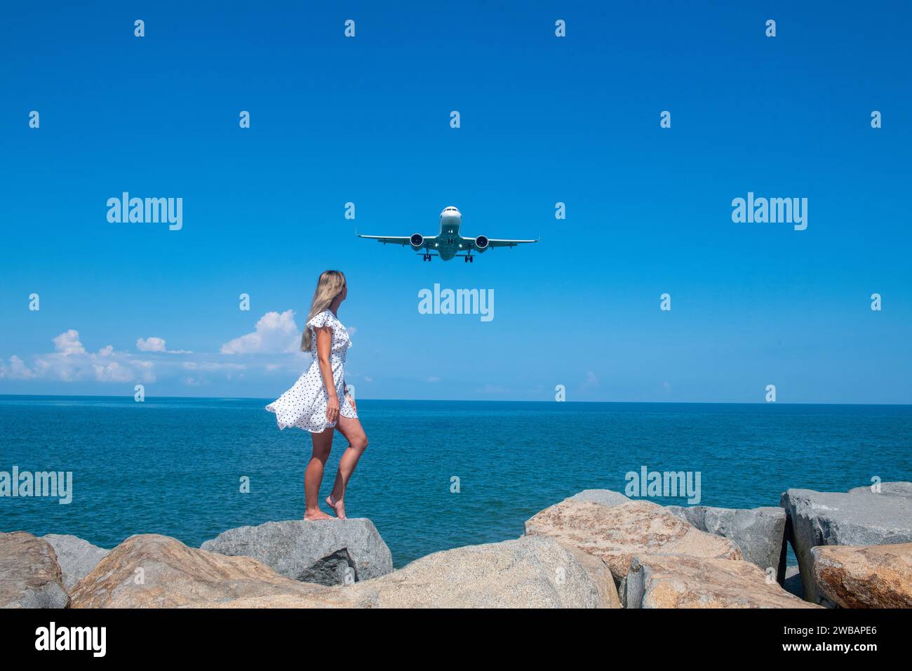 Seaside Fantasy: Girl in White Dress, Stones, Blue Sea, and a Flying ...