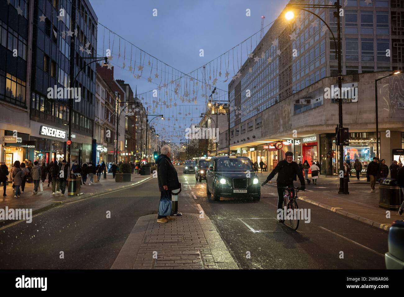 Shoppers brave the cold winter weather during freezing sleet and rain ...