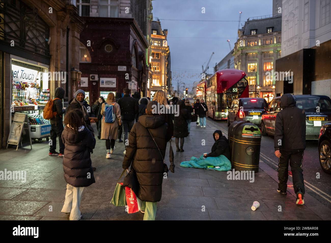Shoppers brave the cold winter weather during freezing sleet and rain ...