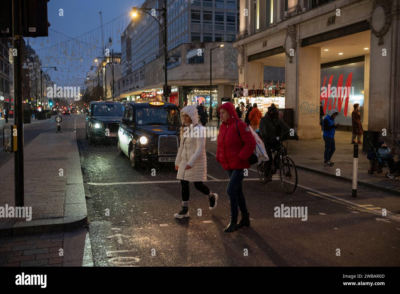 Shoppers brave the cold winter weather during freezing sleet and rain ...