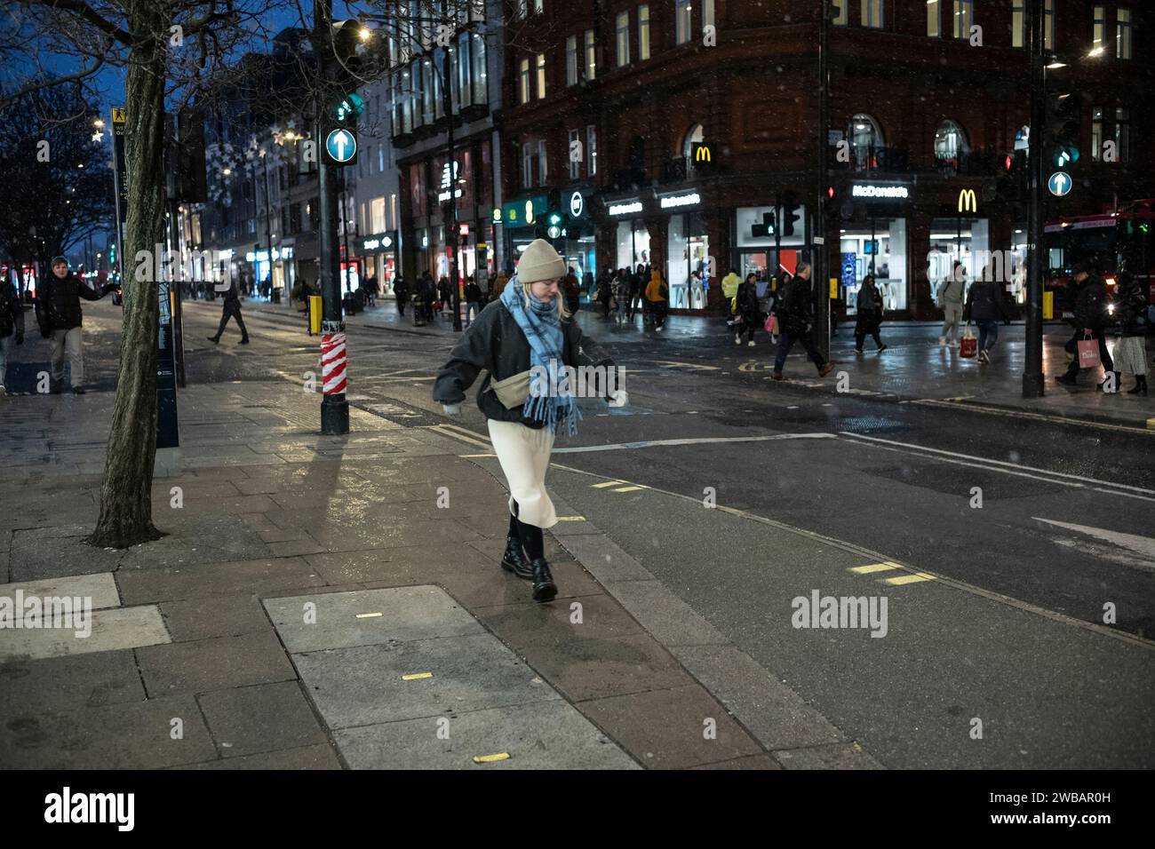 Shoppers brave the cold winter weather during freezing sleet and rain ...