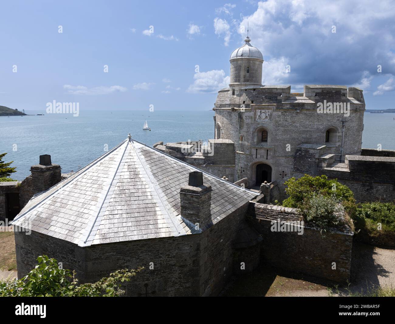 St Maws Castle with single sail yacht on calm sea near Falmouth ...