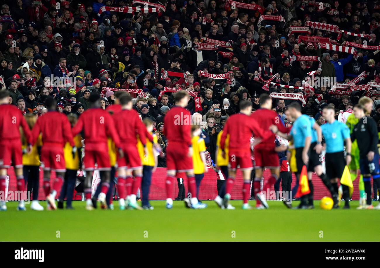 Middlesbrough fans hold up scarves as teams shake hands ahead of the ...