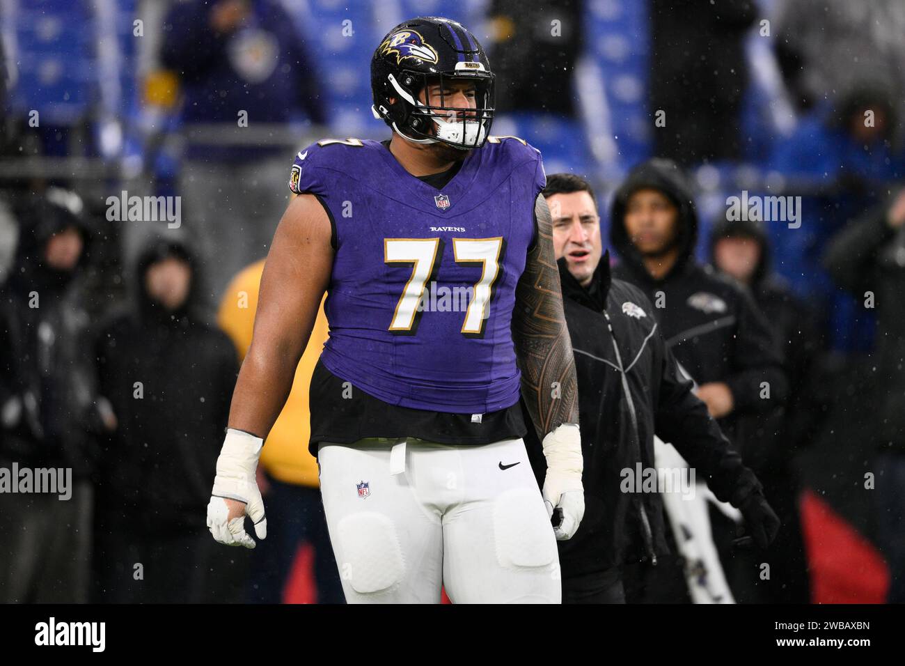 Baltimore Ravens offensive tackle Daniel Faalele (77) works out before ...
