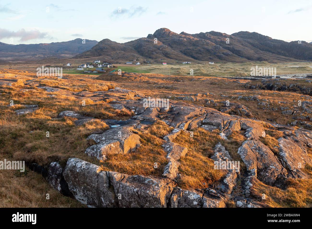 The rural village of Sanna at sunset with the hill Meall Sanna behind ...