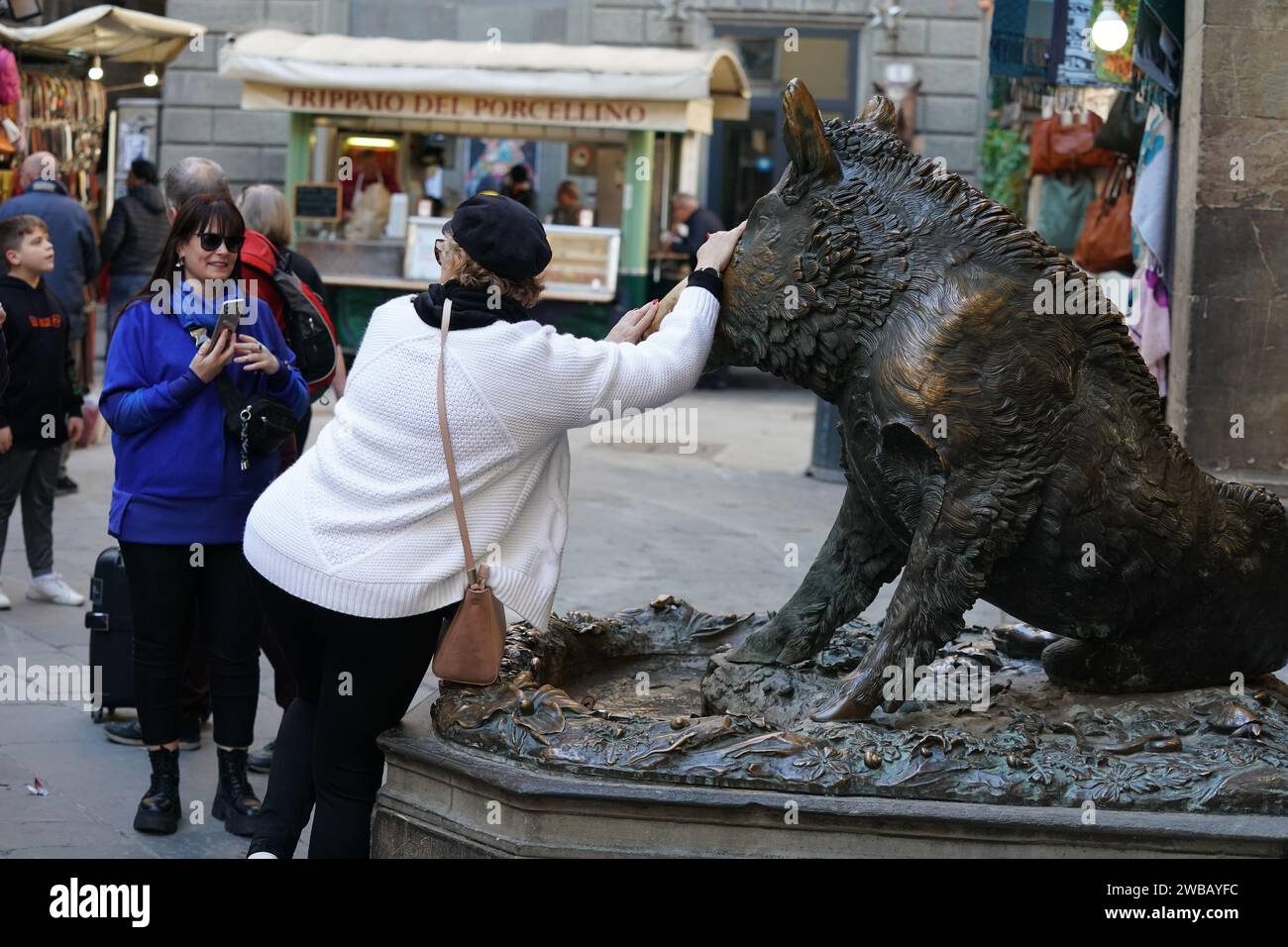 Tourists and visitors gathered around Il Porcellino which is the local ...