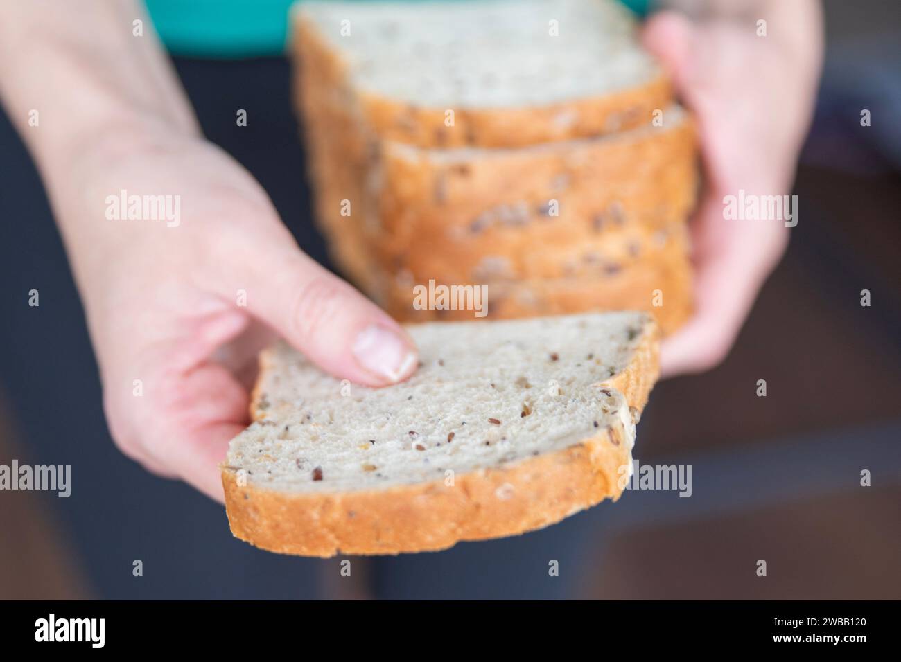 Woman's hands holding slices of bread close-up. The process of ...