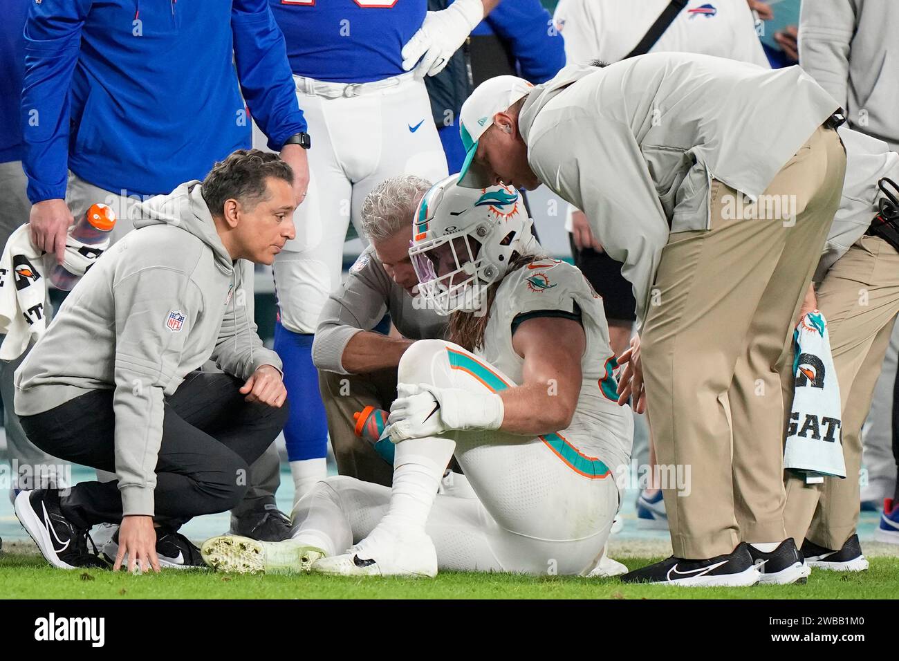 Miami Dolphins linebacker Andrew Van Ginkel is helped on the field ...