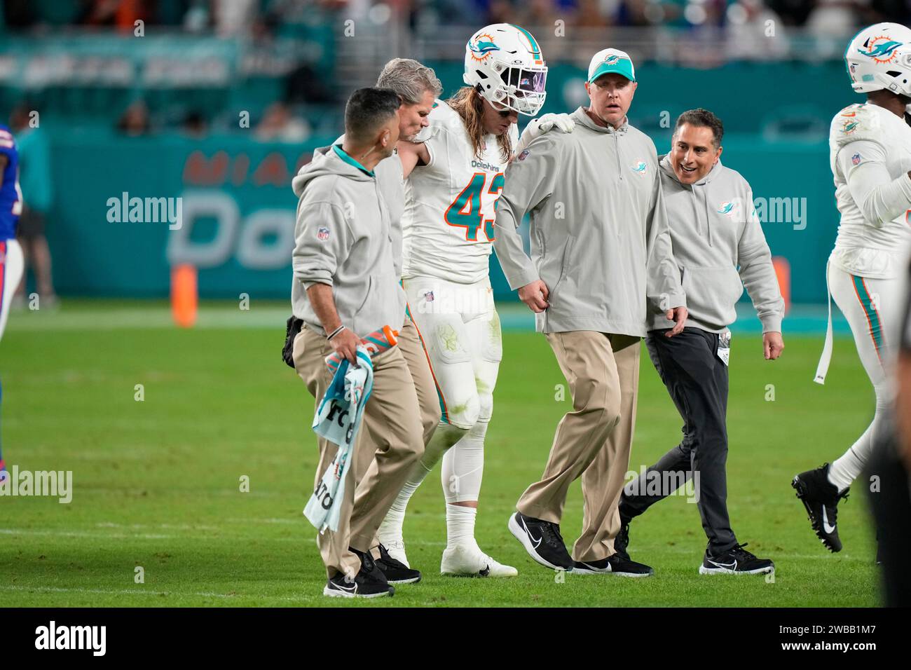 Miami Dolphins linebacker Andrew Van Ginkel (43) is helped off the ...