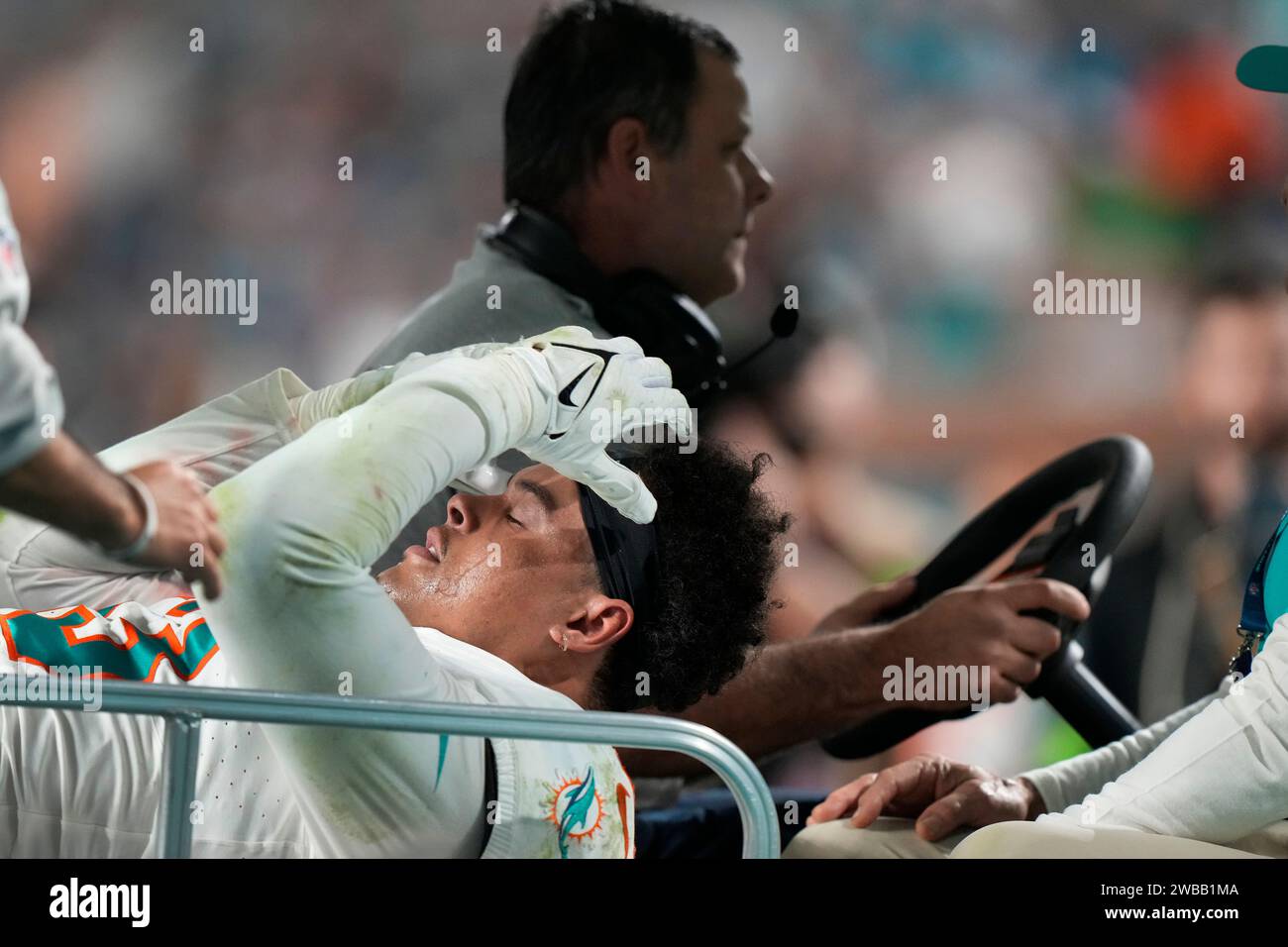 Miami Dolphins linebacker Cameron Goode holds his head as he is carted ...