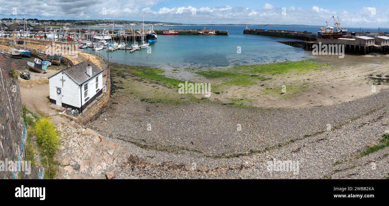Protected industral fishing Harbour at Newlyn at low tide. Newlyn is ...
