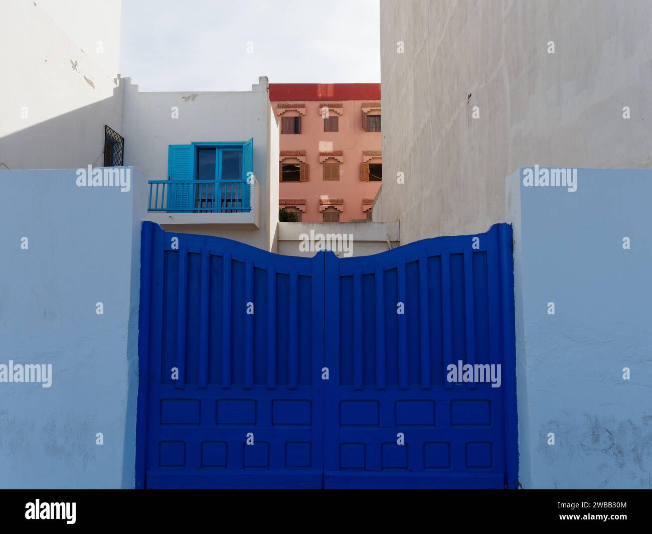 Property with dark blue gate and different shades of blue with a light ...