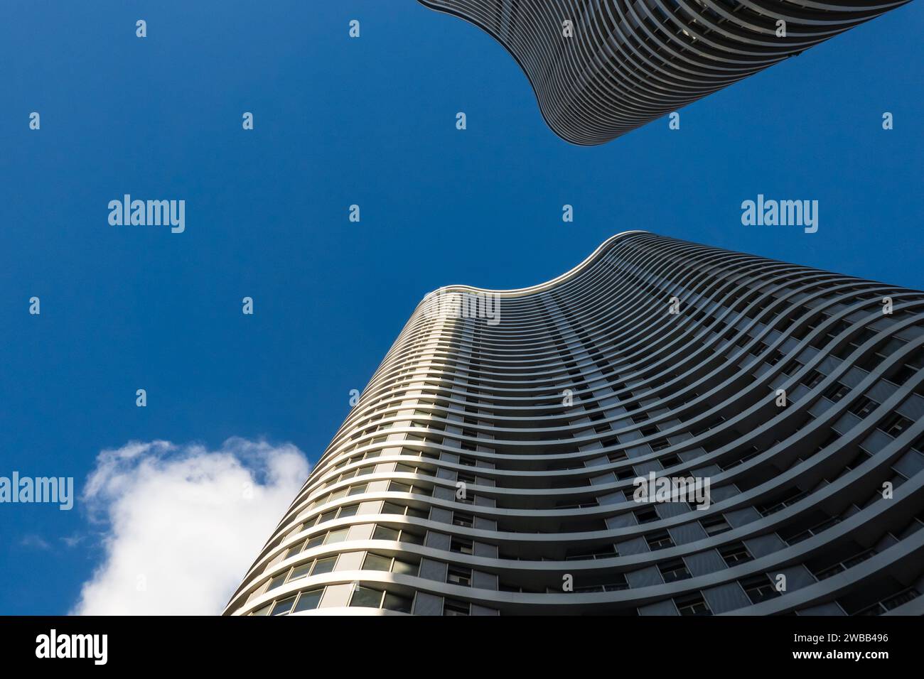 Curvilinear modern skyscrapers soar against a clear blue sky ...