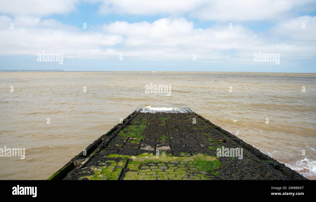 Slipway with slippery moss in the ocean. Cloudy sky Stock Photo - Alamy