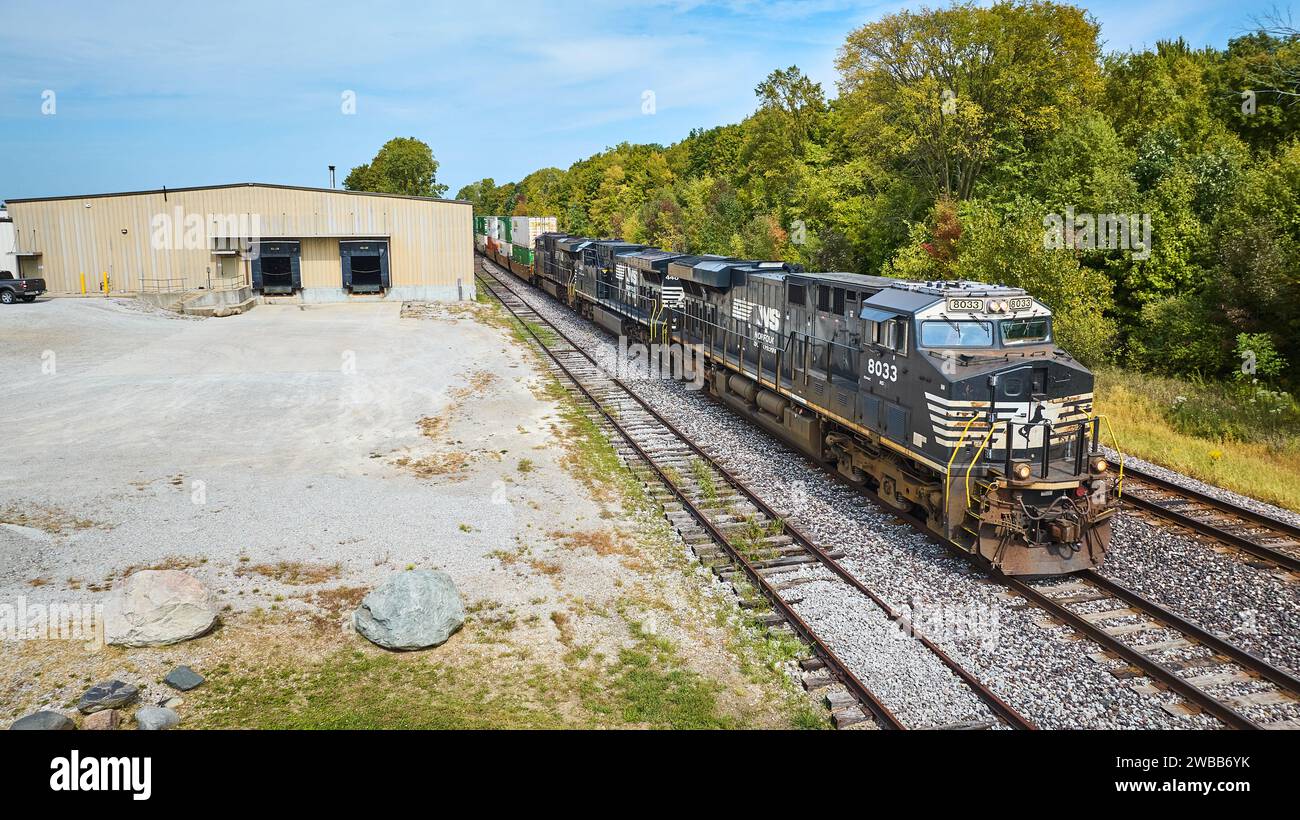 Aerial View of Freight Train and Industrial Warehouse in Spencerville ...