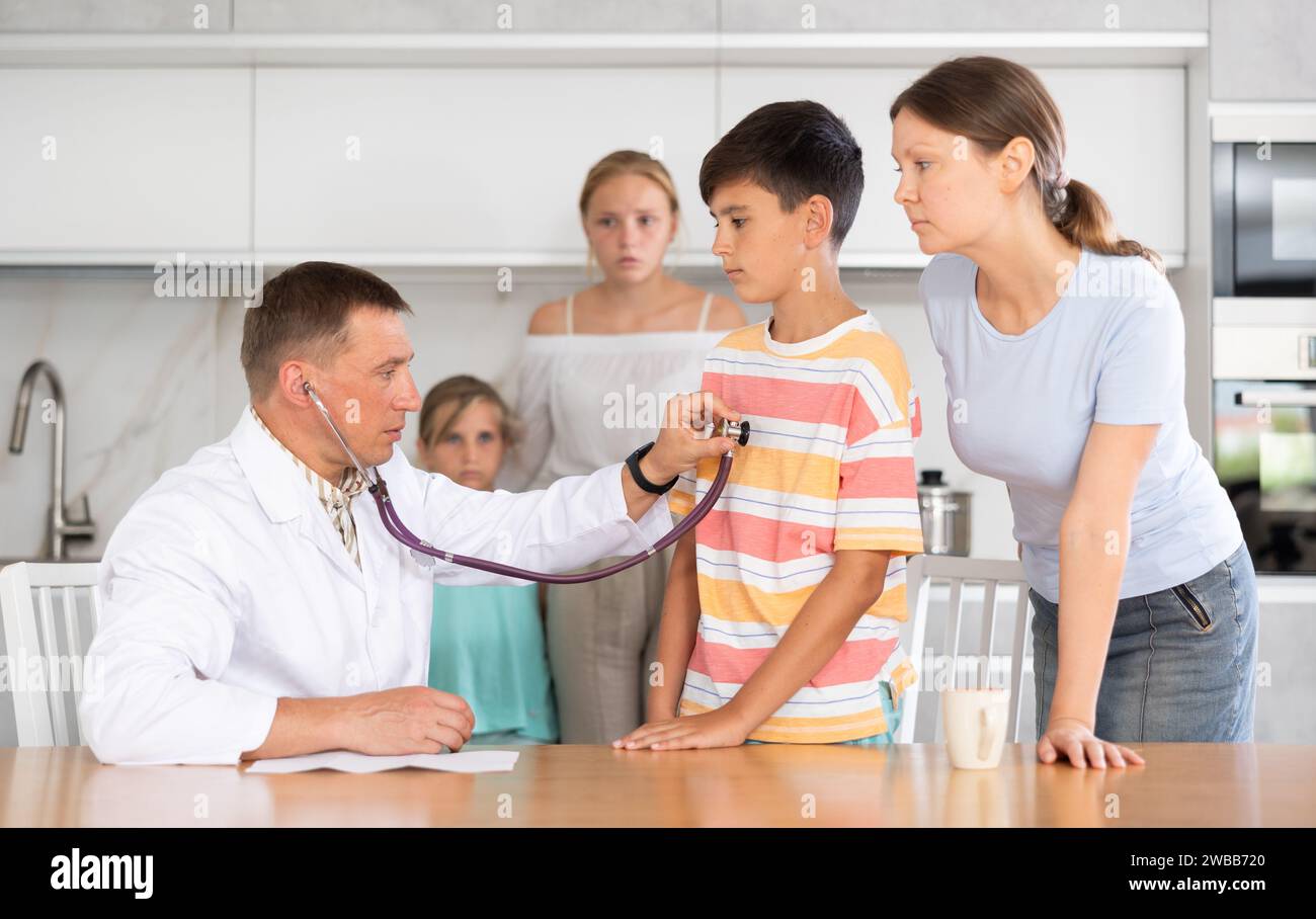 Family male doctor visit at home. Doctor examining children Stock Photo ...