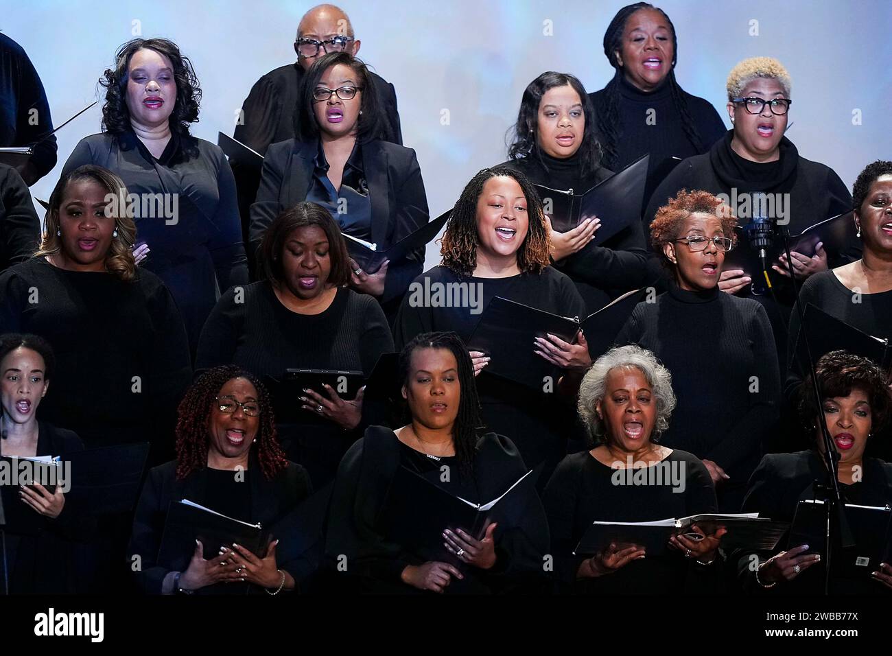 Members of the Community Choir sing during funeral services for former ...