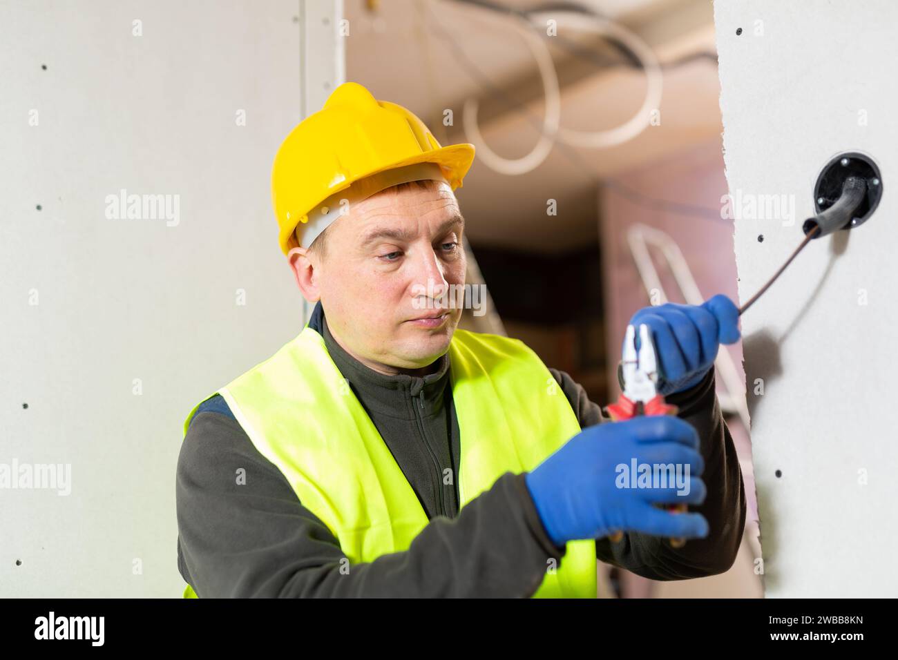 Electrician installing electricity in new house Stock Photo - Alamy
