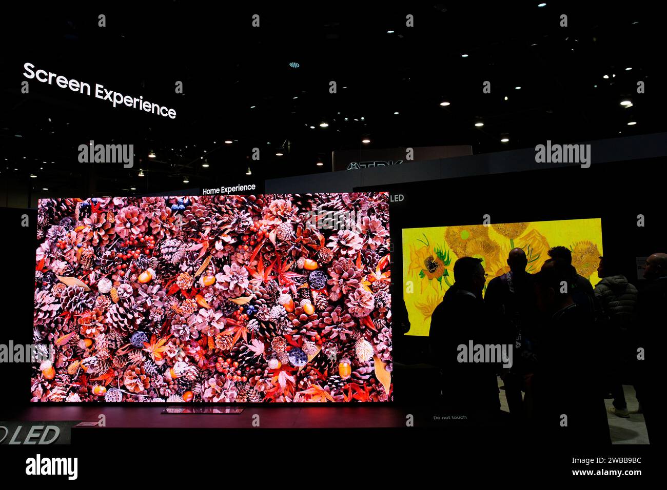 People tour a Samsung Micro LED exhibit at the Samsung booth during the ...