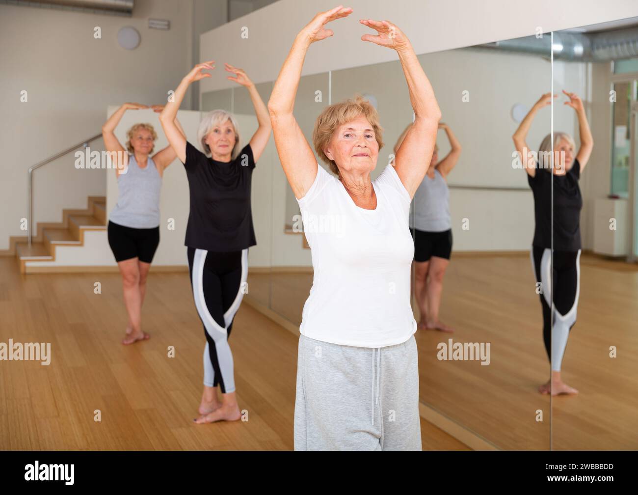 Mature women are standing in the 5th position of the ballet stand Stock ...