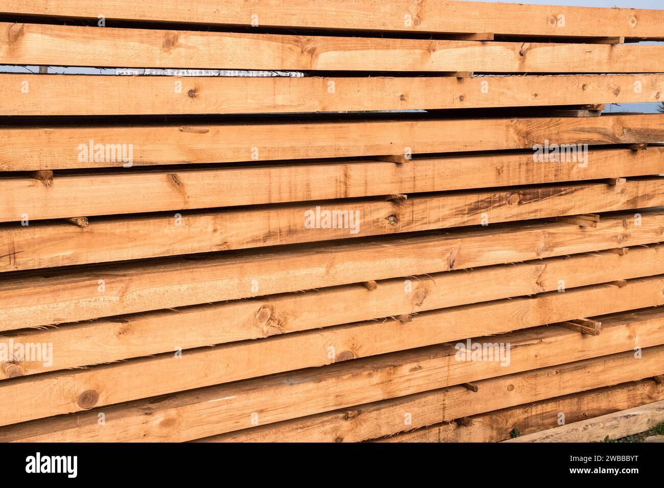 Stacked wooden pine beams closeup Stock Photo - Alamy