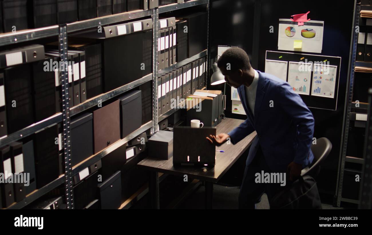 Private detective stands and walks out of office, clutching laptop bag ...