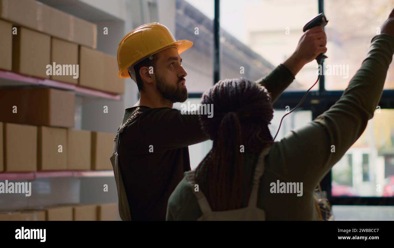 African american warehouse manager and assistant perform inventory ...