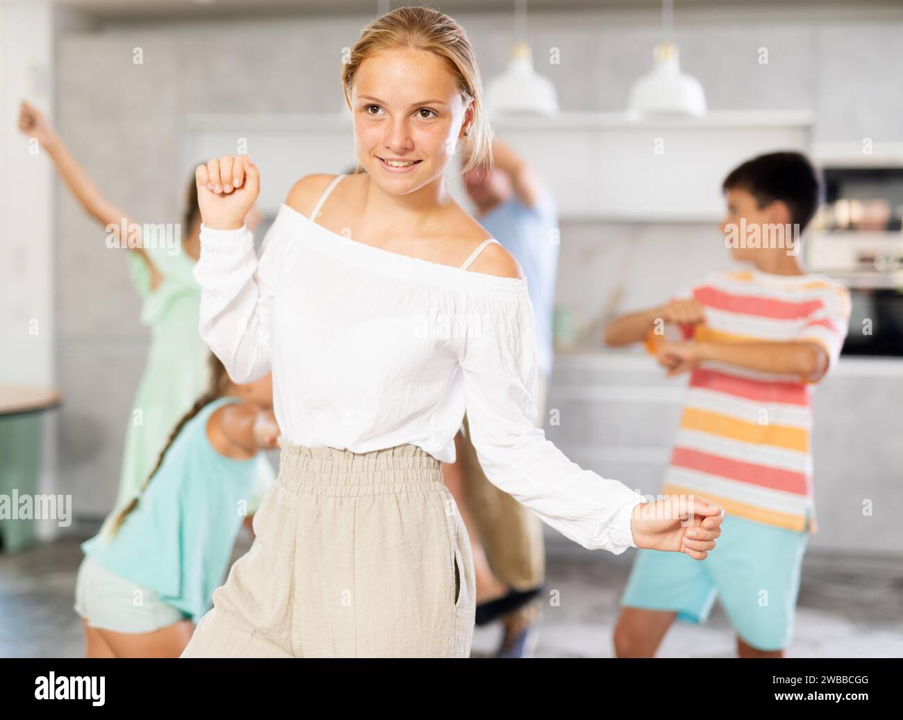 Behind cheerful girl, big family of parents, sisters, brother is ...