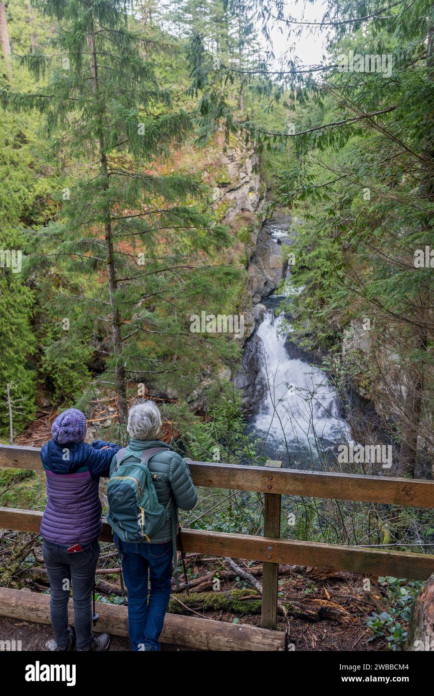 Senior women looking at the upper Twin Falls waterfall in the Olallie ...
