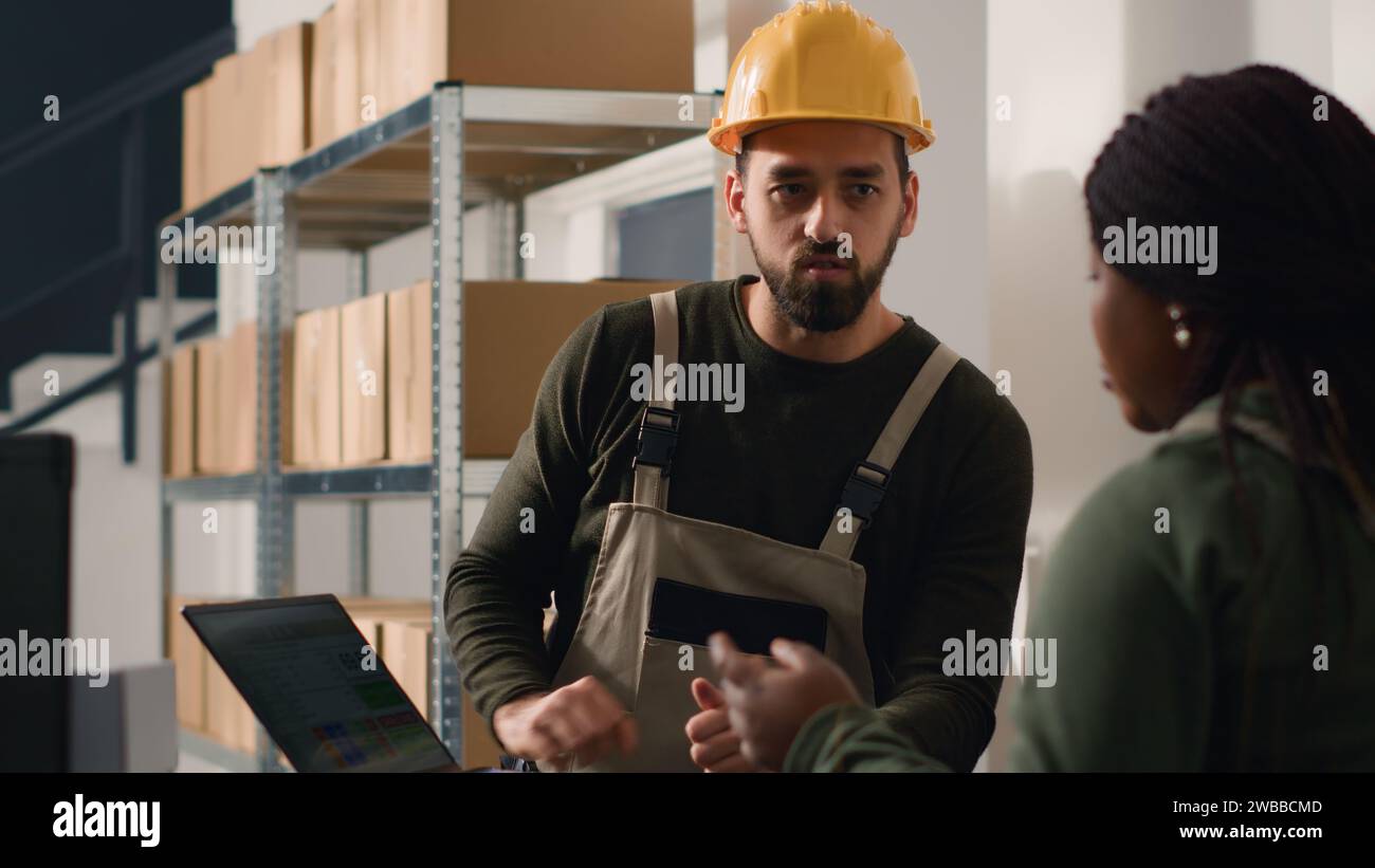 Storage facility warehouse supervisor carrying out the logistics of ...