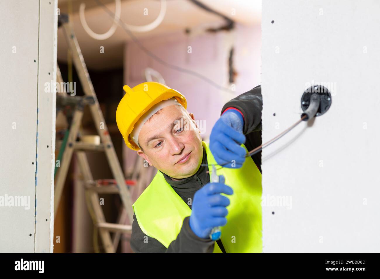 Electrician working with wires in apartment Stock Photo - Alamy