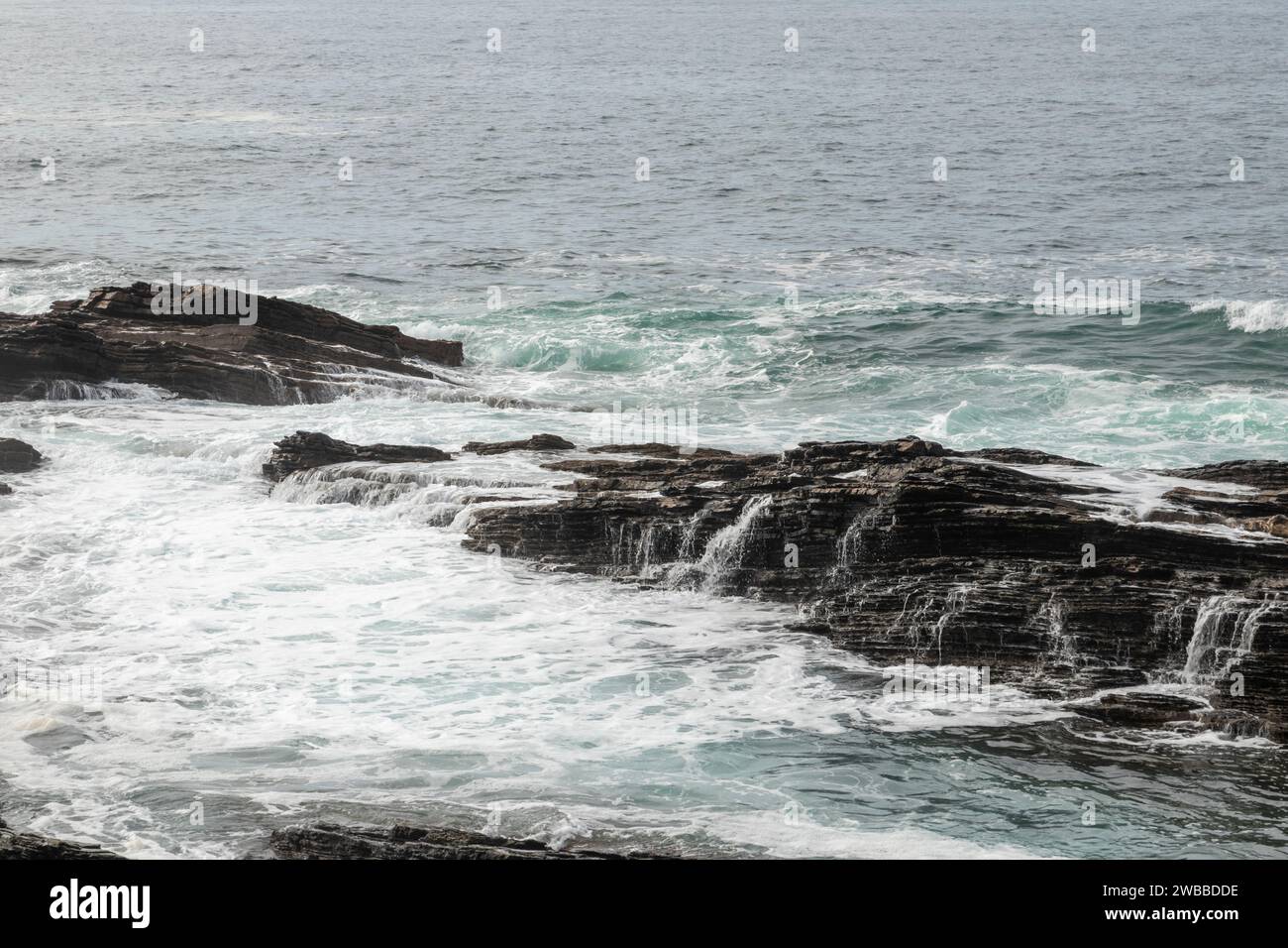 Rocky coastline dark jagged rocks hi-res stock photography and images ...