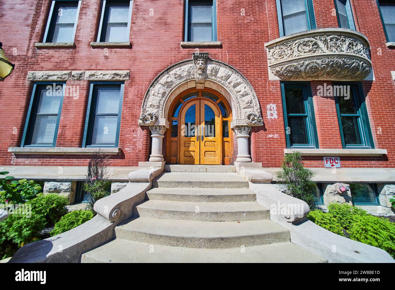 Elegant Red Brick Building Entrance with Arch and Columns Stock Photo ...