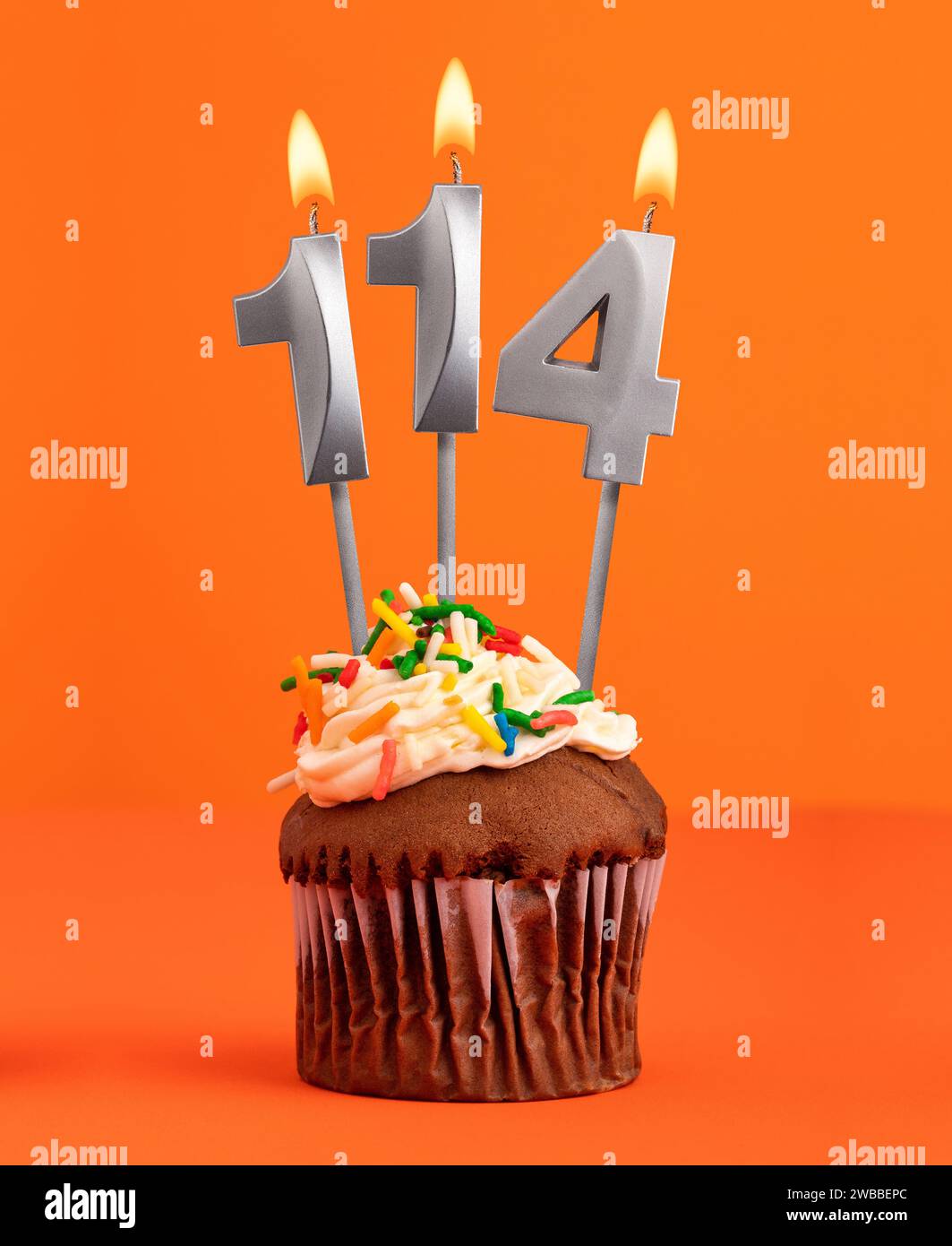 Birthday cupcake with number 114 candle - Orange color background Stock ...