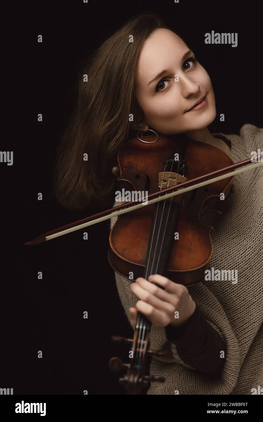 The violin cradled lovingly, this musician's joyful expression captures ...