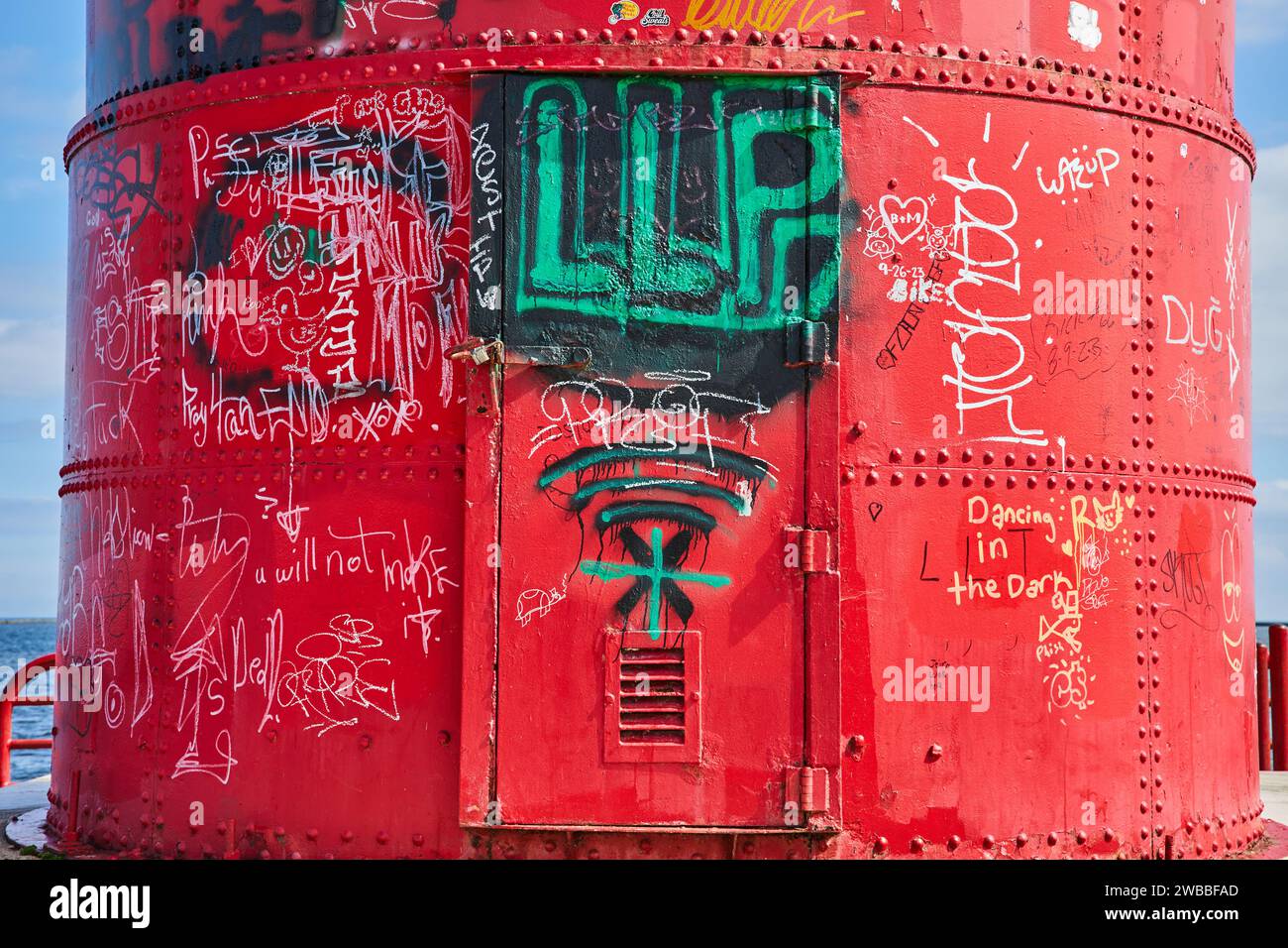 Red Lighthouse with Vibrant Graffiti Art by the Sea Stock Photo - Alamy