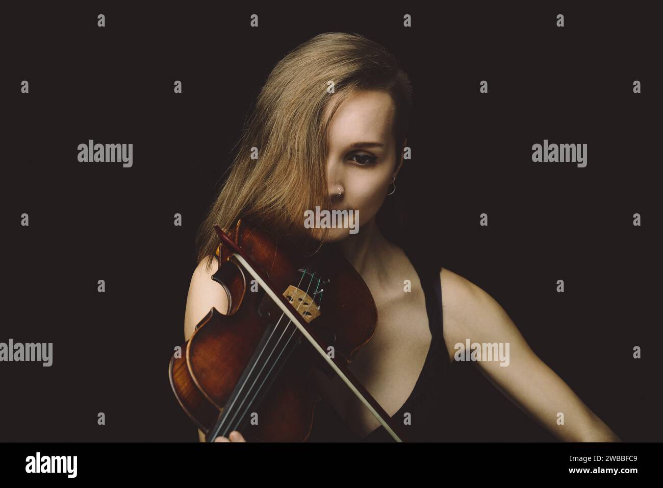 violinist's poise and intense gaze reflect the meticulous skill and ...